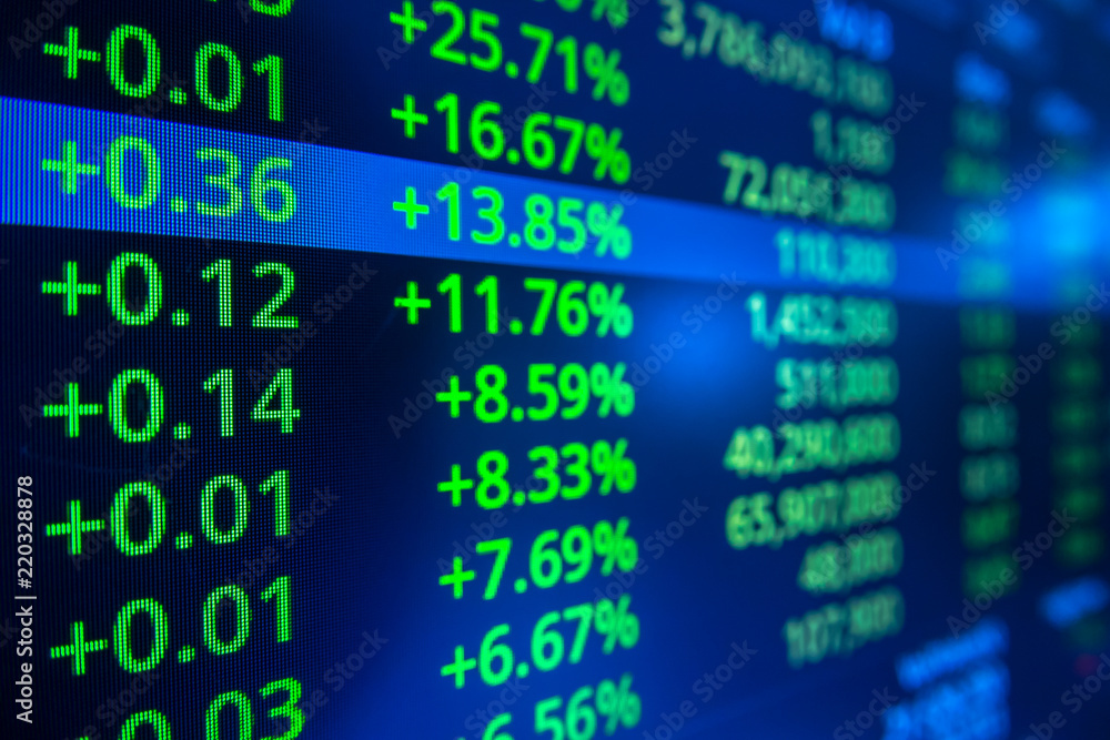 Stock market graph analysis. Stock market data on LED display on laptop ...