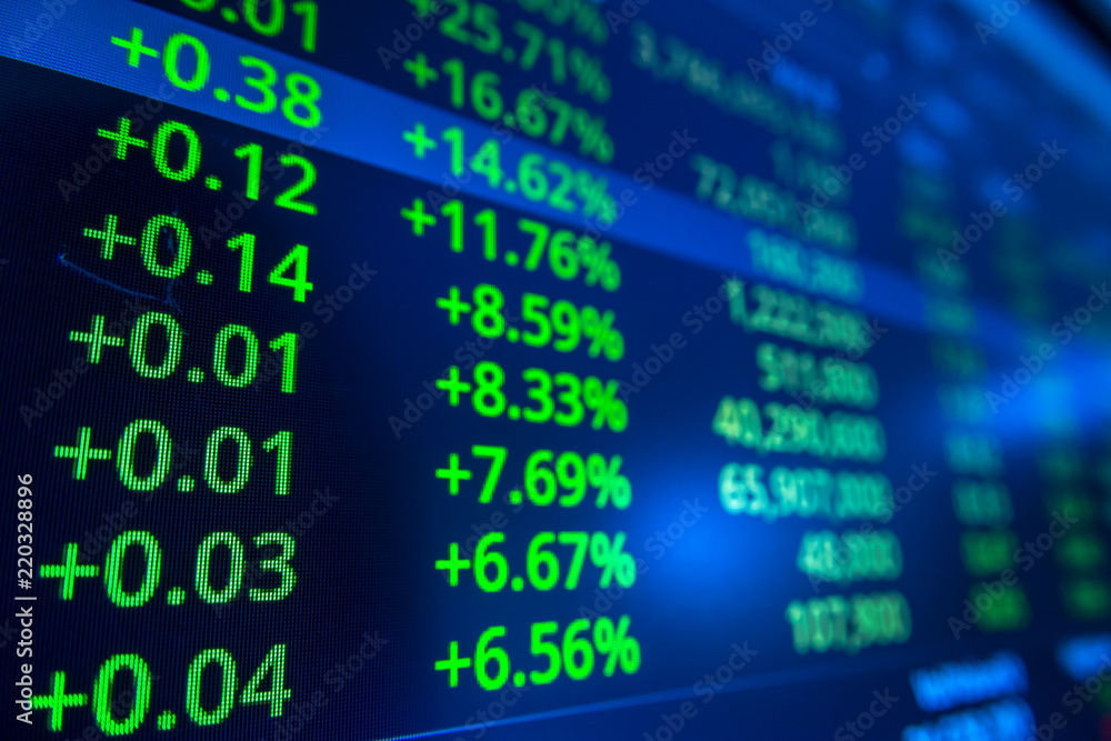 Stock market graph analysis. Stock market data on LED display on laptop ...