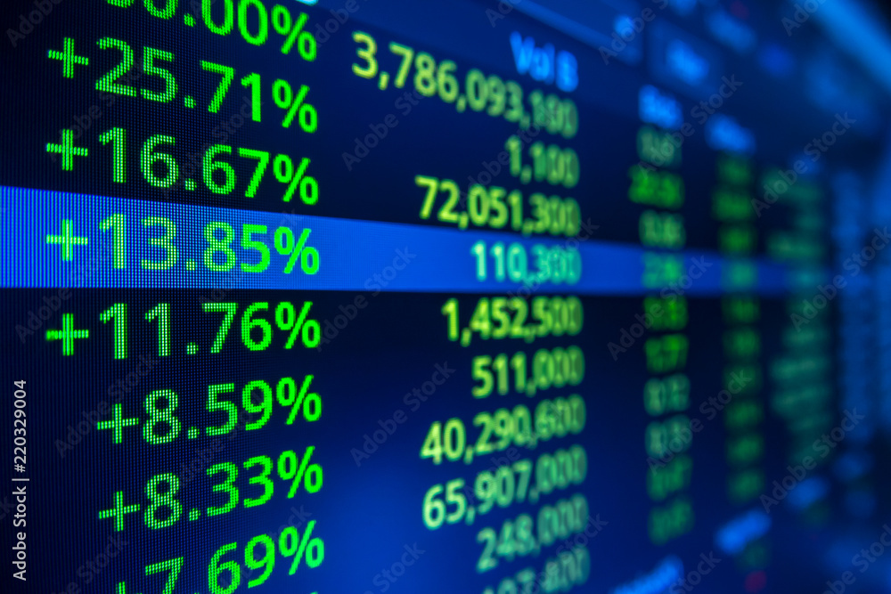 Stock market graph analysis. Stock market data on LED display on laptop ...