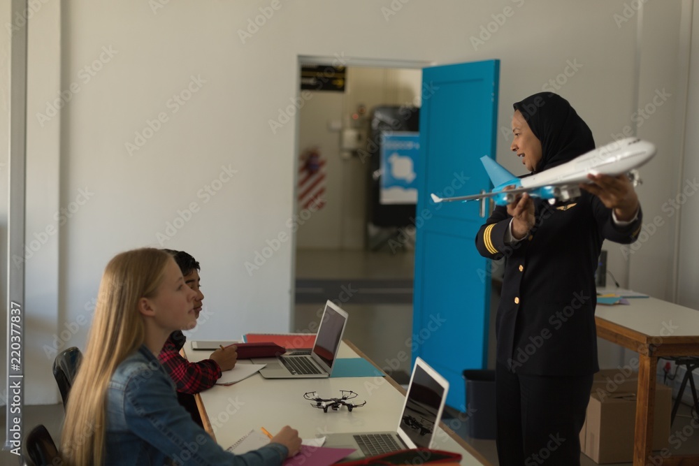 Female pilot teaching about model plane to kids Stock Photo | Adobe Stock