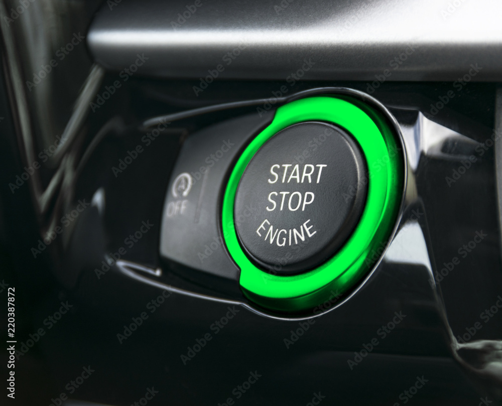 Car dashboard with focus on Green engine start stop button. Modern car ...