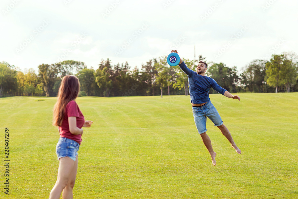 couple in love playing frisbee in the park, the concept of a healthy ...