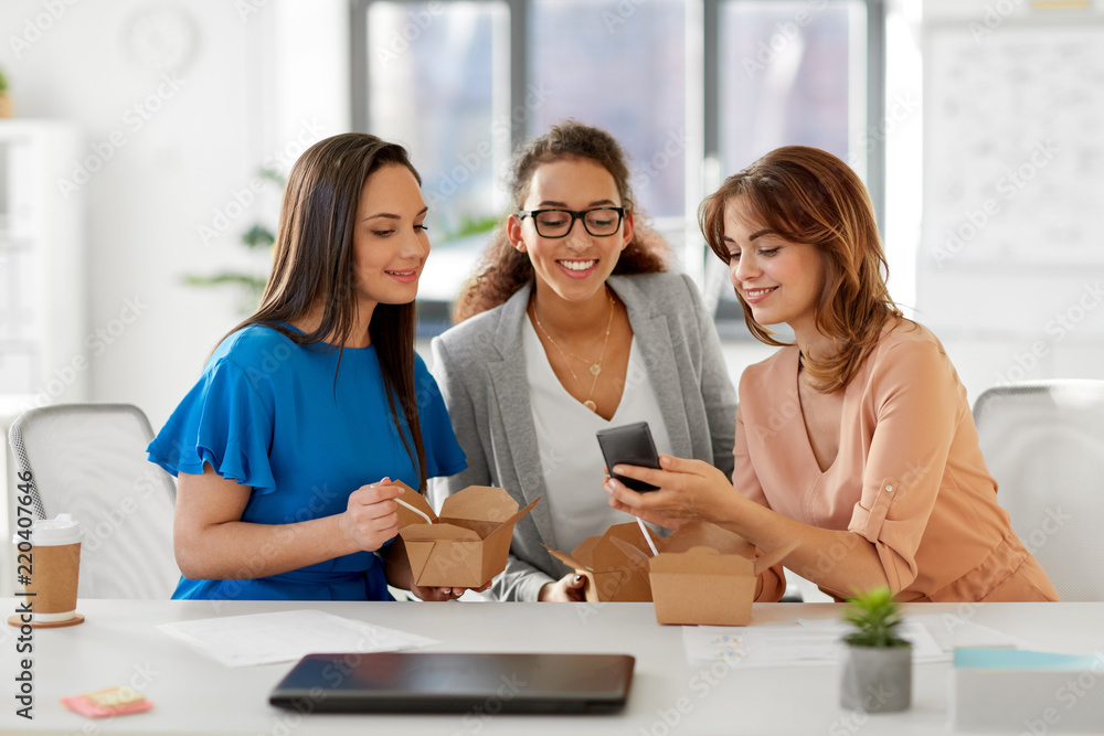 business lunch and people concept - happy businesswomen with smartphone ...