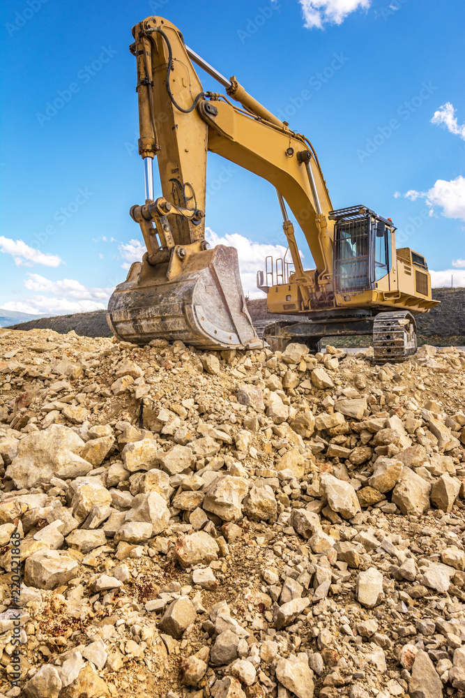 Big excavator moving earth in the construction works of a road Stock ...