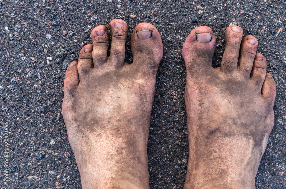 Dirty feet in the mud. A person walks through the mud. Dirty feet after ...