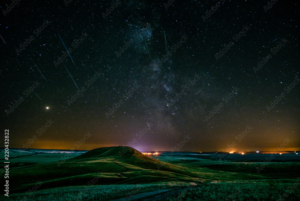 Milky way, Mars and Perseids meteor shower in clear night sky in front ...