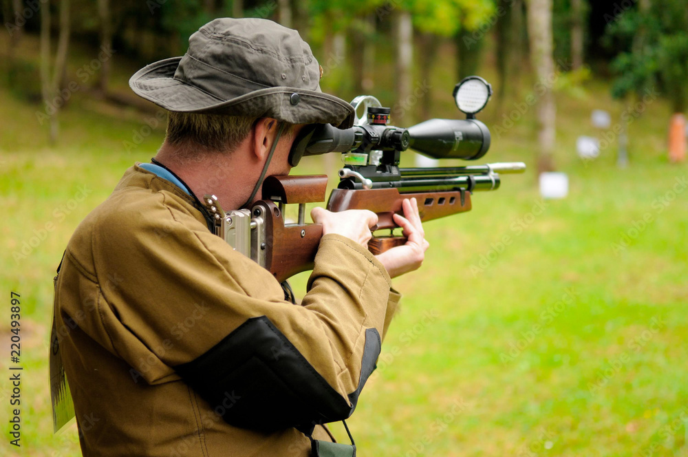 man shooting a target with an air rifle Stock Photo | Adobe Stock
