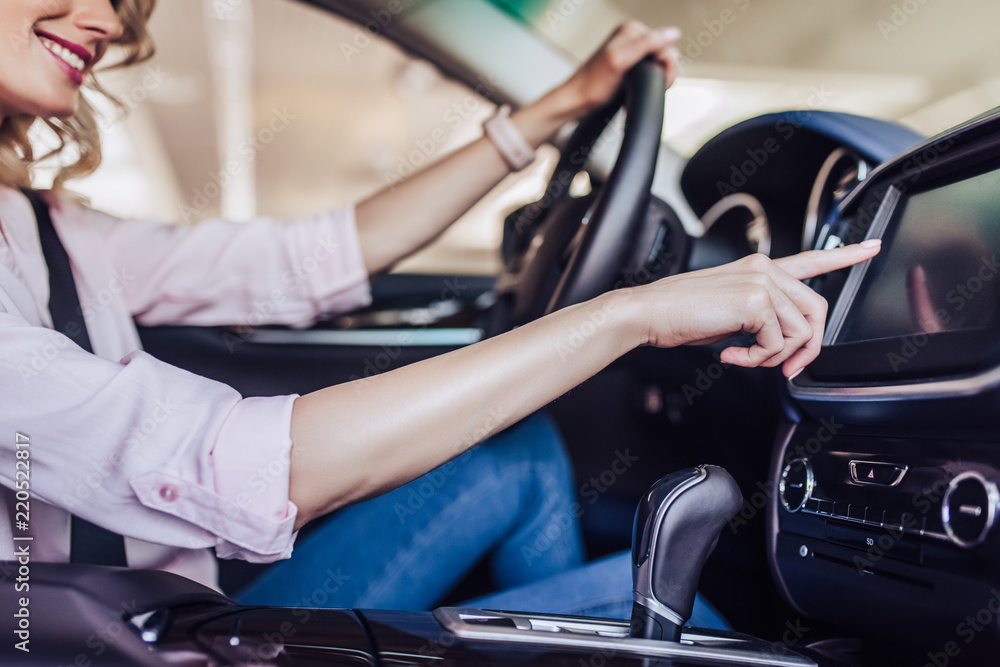 woman pushing button on the dashboard in the car Stock Photo | Adobe Stock