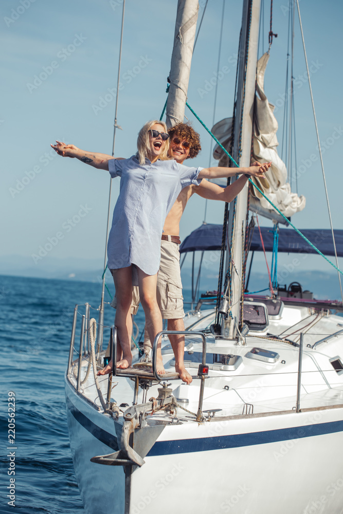 People standing on bow of a sailing boat with hands aside like dramatic ...