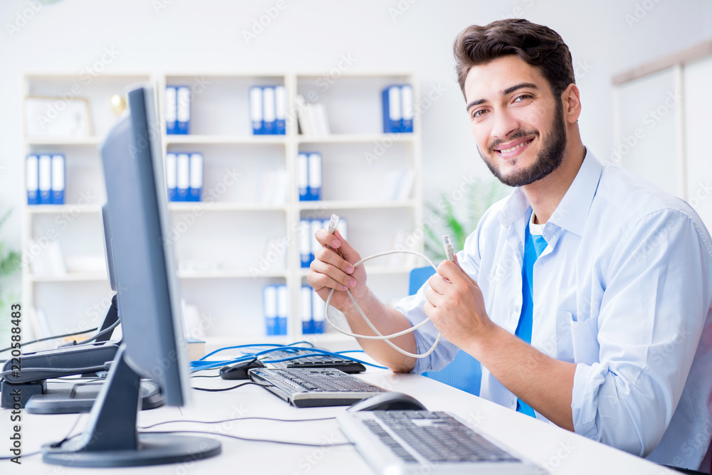 IT technician looking at IT equipment Stock-Foto | Adobe Stock