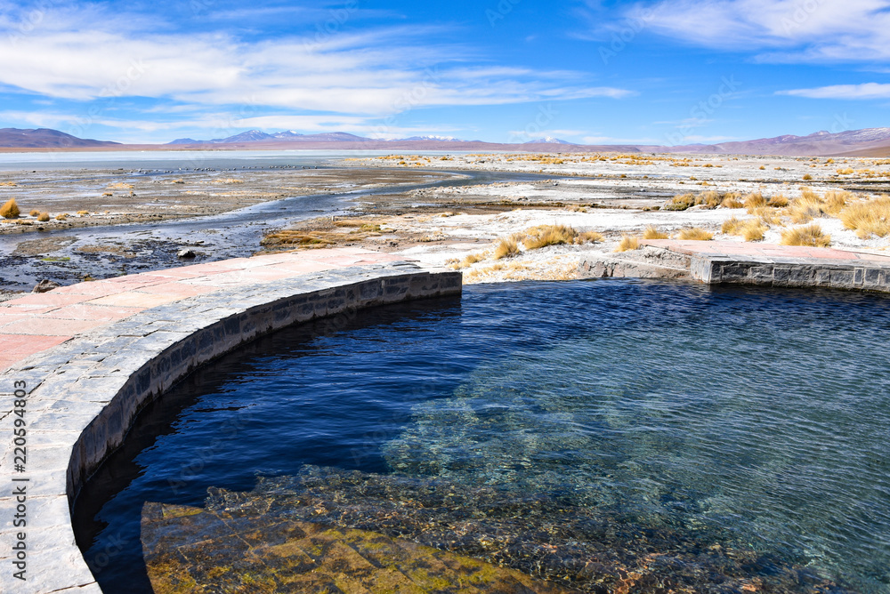 Laguna y Termas de Polques hot springs pool with the Salar de Chalviri ...