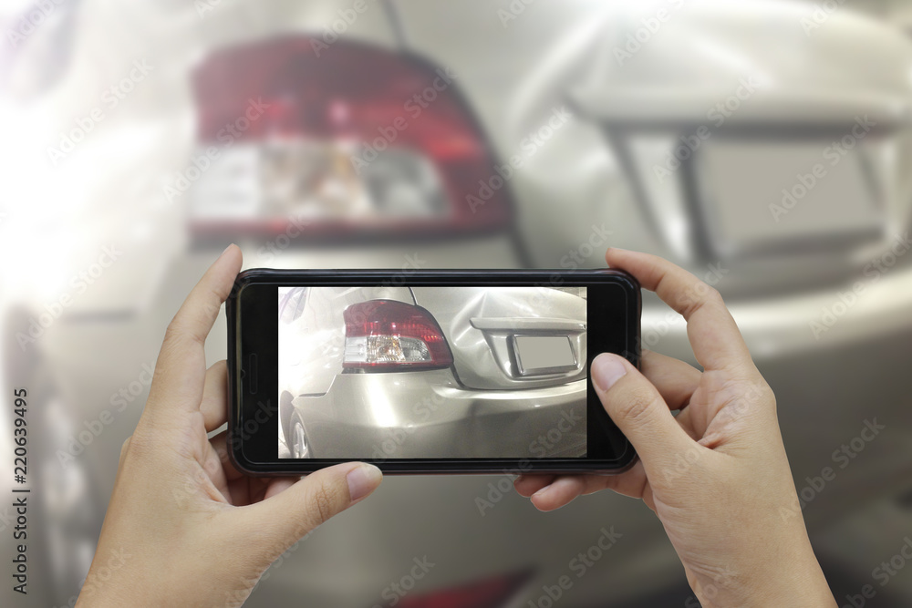 Hand holding smart phone take a photo at The scene of a car crash, car ...