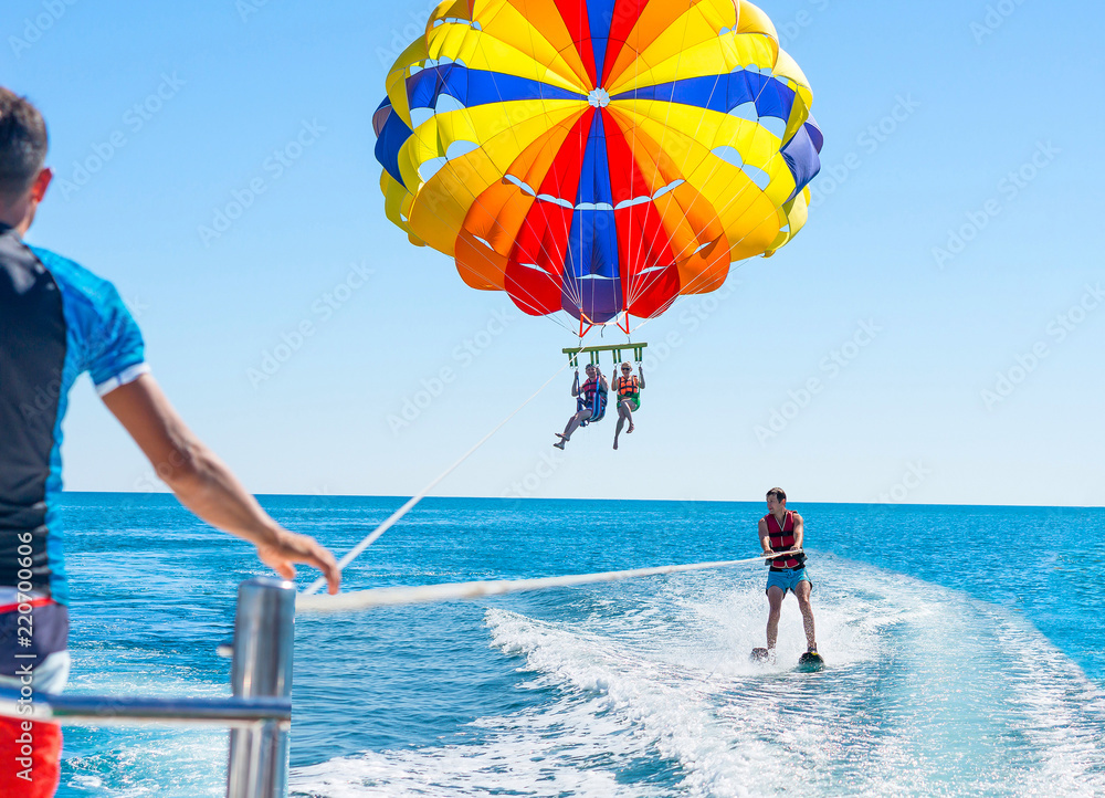 Happy couple Parasailing in Dominicana beach in summer. Couple under ...