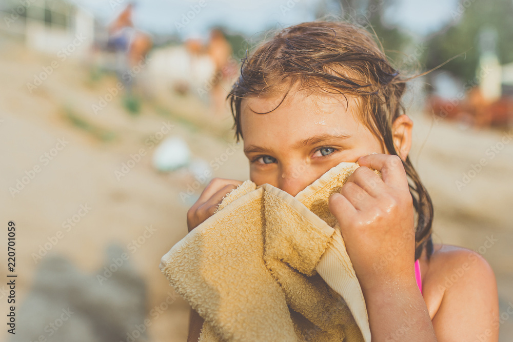 Little girl wiping face with a towel Stock Photo | Adobe Stock
