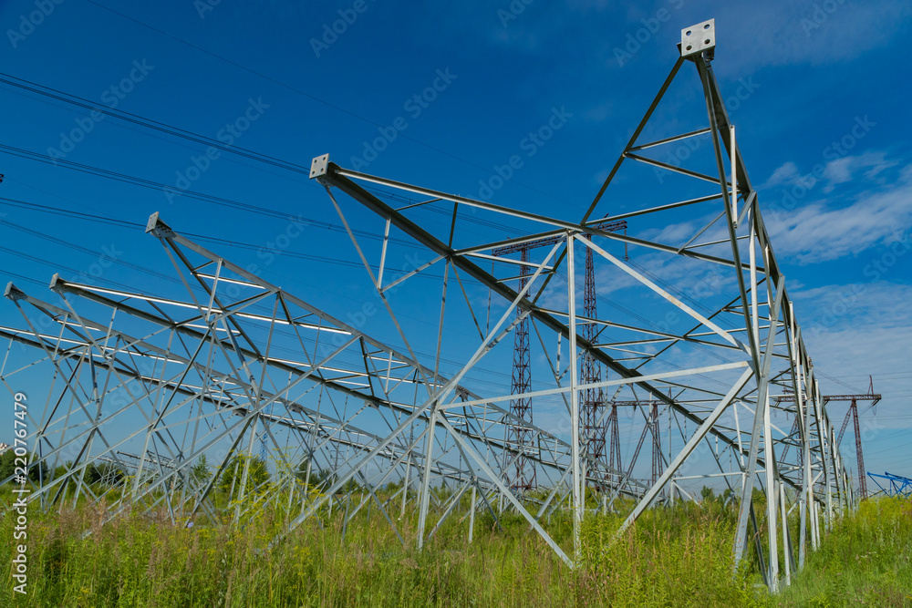 Foto de New poles for power lines lying on the ground. For the next ...