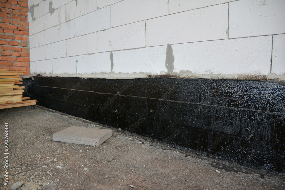 Foto de Foundation bitumen waterproofing. Building house construction ...