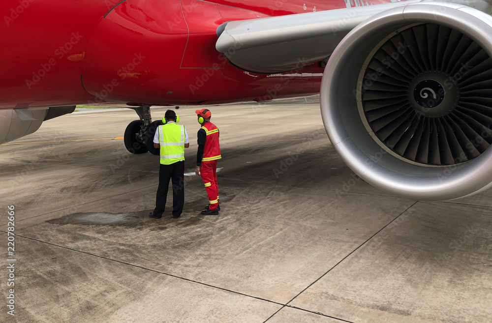 Technicians in charge in an inspection, prepare the aircraft for flight ...