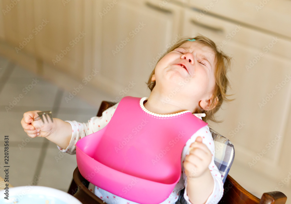 Sad crying baby girl. Toddler does not eating. Hysterical child ...