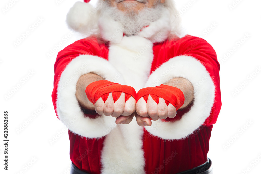 Christmas. Close up of two fists of Santa Claus with a red bandage ...