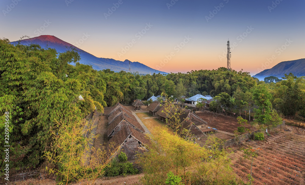 Traditional house of Bayan Sembalun Lombok with mount Rinjani as a ...