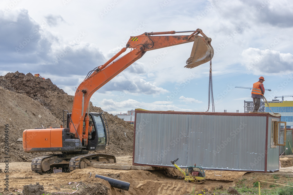 Loading the cabins with an excavator Stock Photo | Adobe Stock