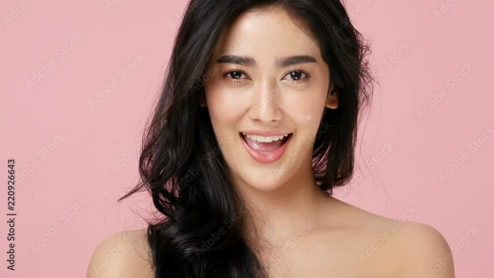 Portrait of beautiful woman with happy emotion at pink background ...