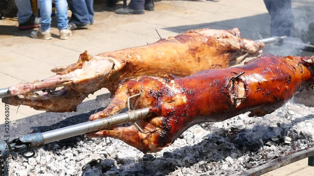 Lamb spinning on spit - Cooking grilled lamb carcasses on the street ...