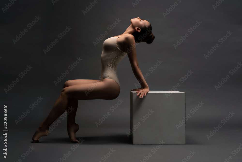 Sexy girl in beige body arching her back view Stock Photo | Adobe Stock