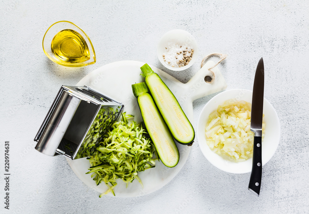raw ingredients on the table. zucchini grate and finely chopped onions ...