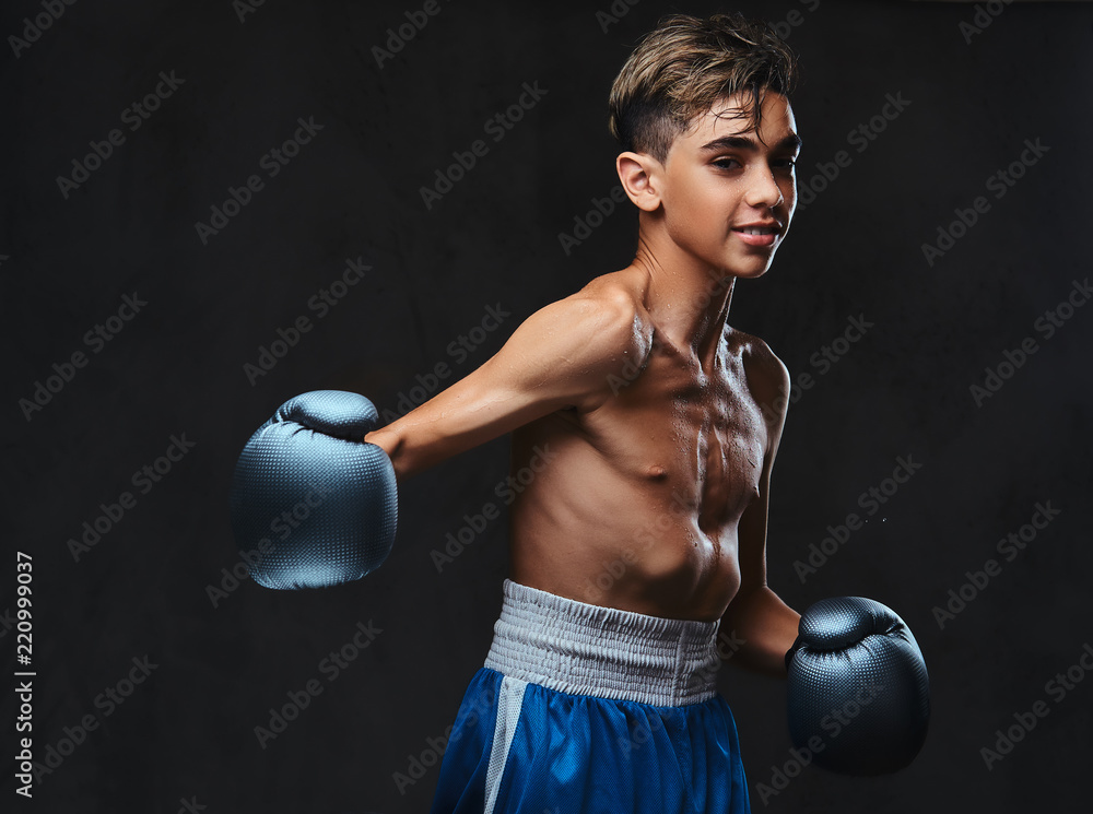Handsome shirtless young boxer during boxing exercises, focused on ...