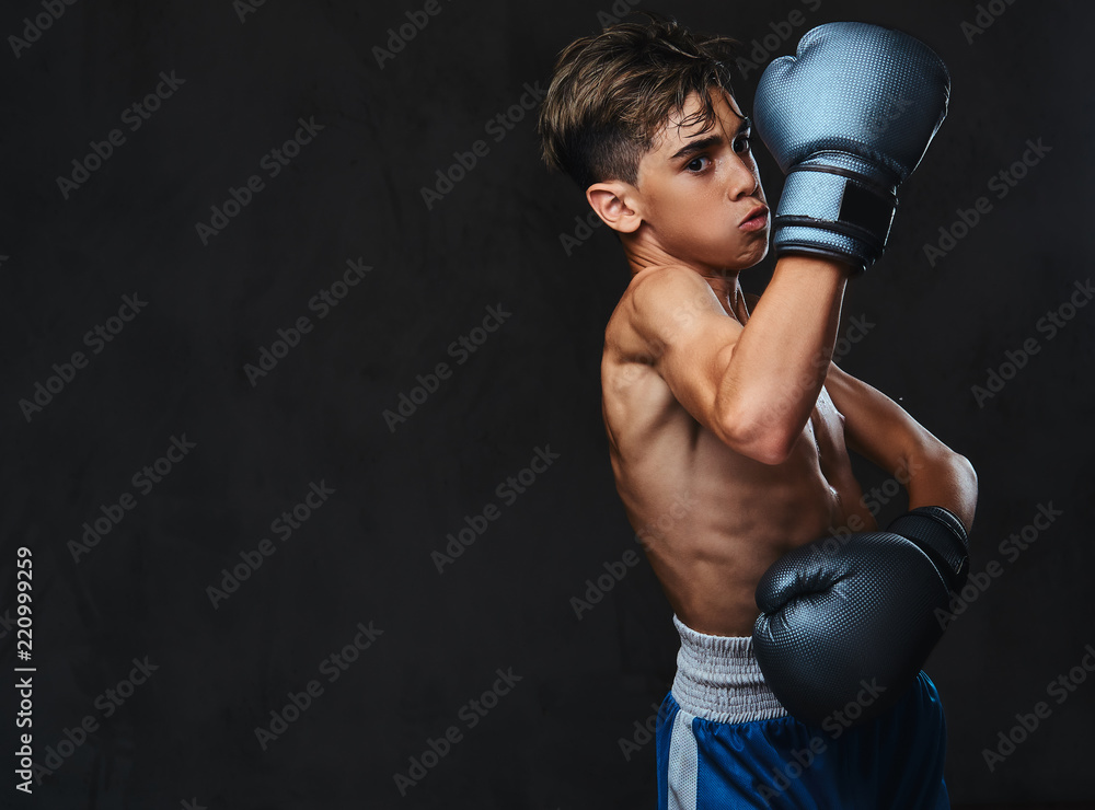Handsome shirtless young boxer during boxing exercises, focused on ...