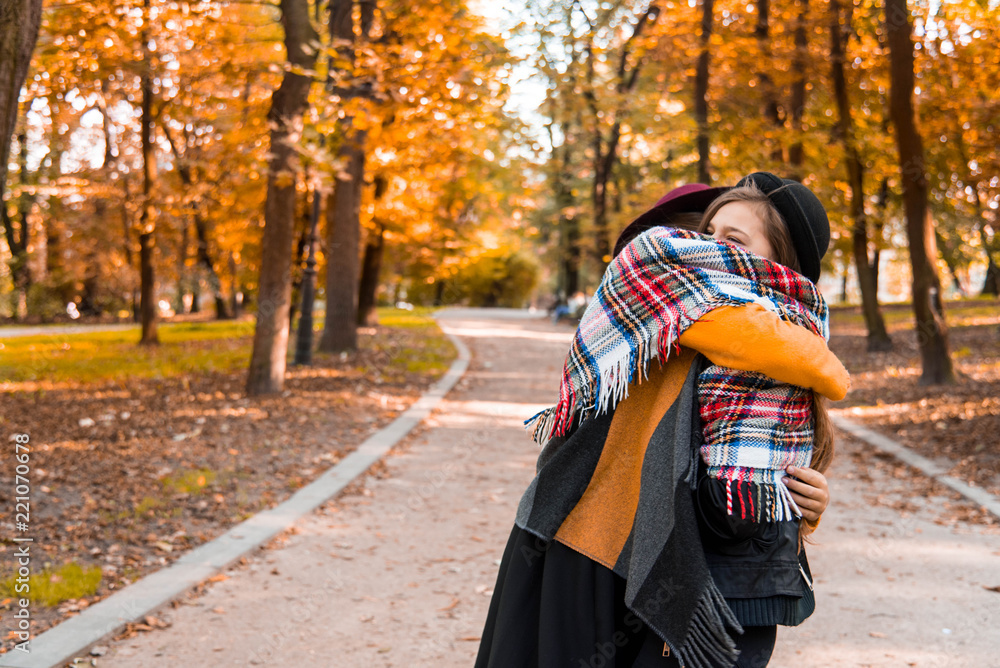 Beautiful young girl resting on street. Emotional conversation sisters ...