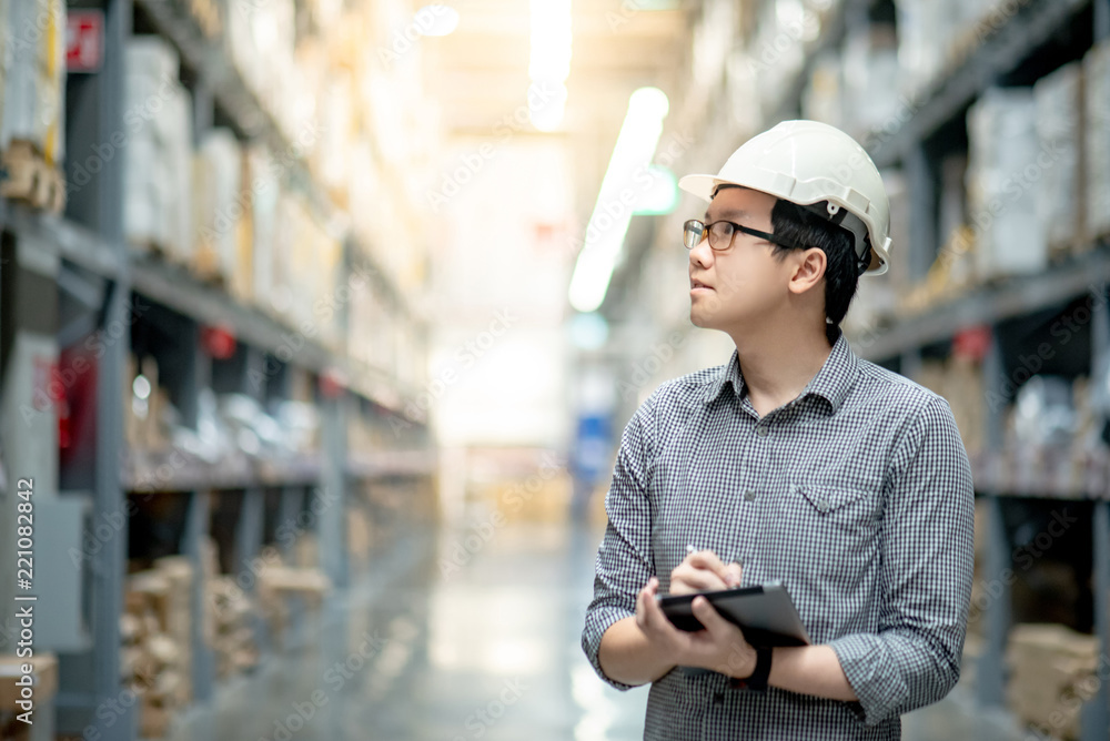 Young Asian man worker wearing safety helmet and eyeglasses doing ...