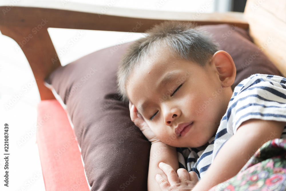 Take a nap, Asian boy sleeping on a wooden sofa for siesta. Adorable ...