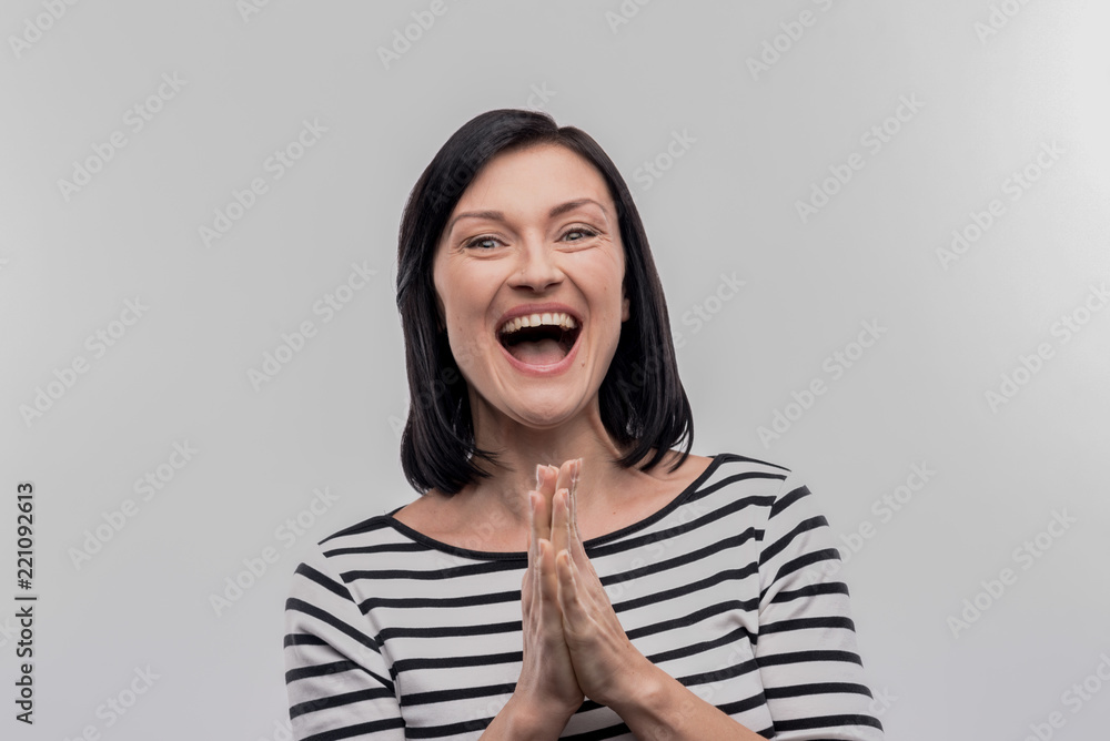Thankful woman. Happy beautiful beaming woman feeling very thankful for ...