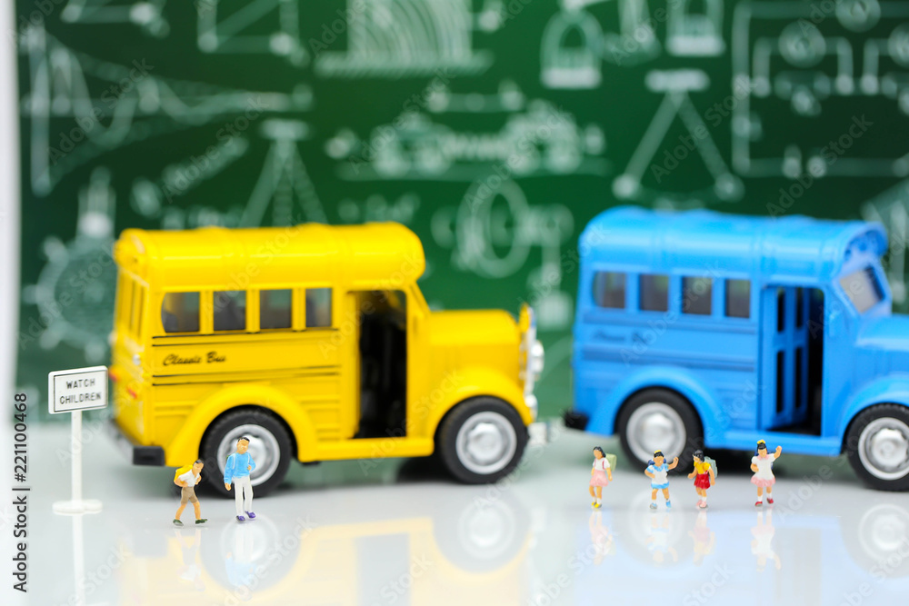 Miniature people : A group of young children getting on the schoolbus ...