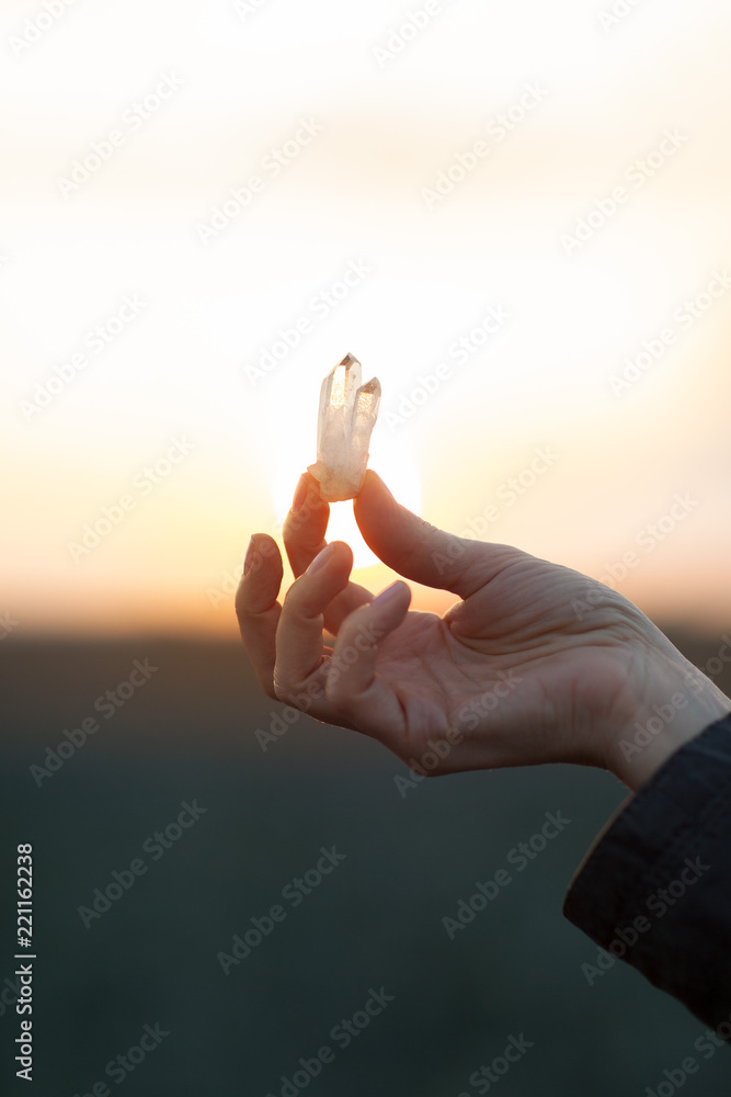Beautiful woman hands holding little quartz crystals in the sunlight ...