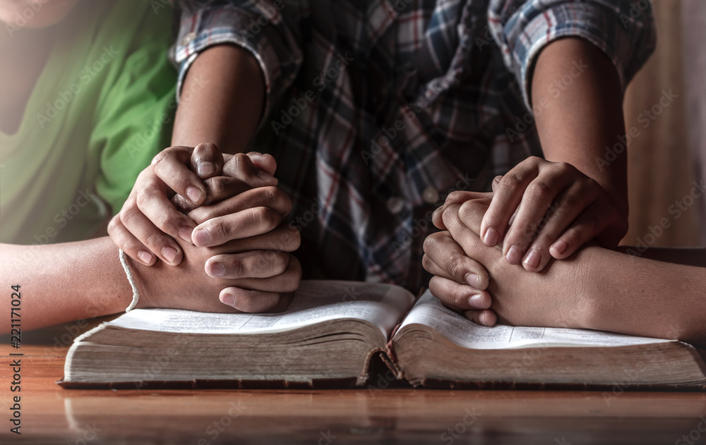 christian young group praying on wooden table with open bible, prayer ...