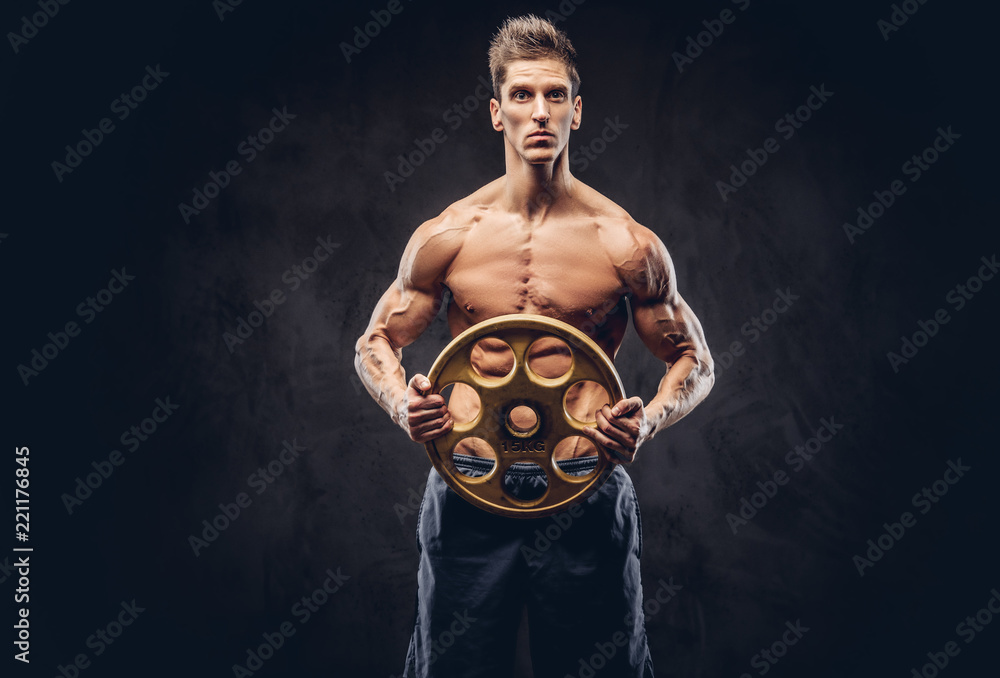 Handsome shirtless ectomorph bodybuilder with stylish hair posing with ...
