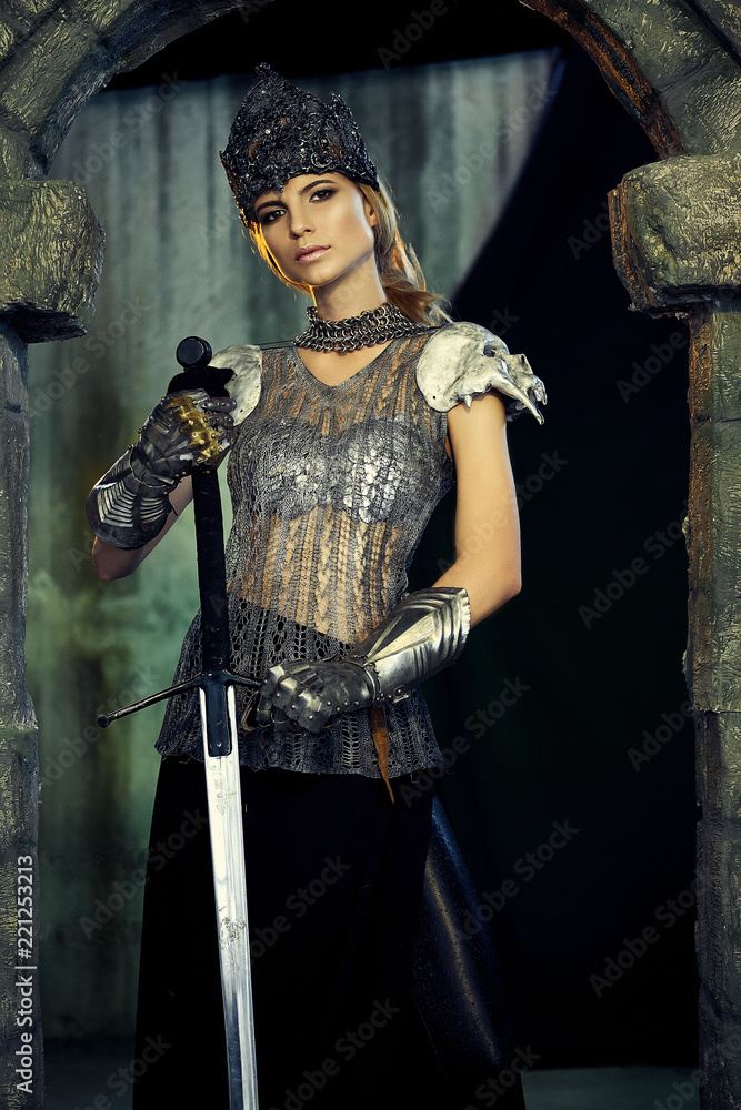 girl in armor with a sword and a crown Stock Photo | Adobe Stock