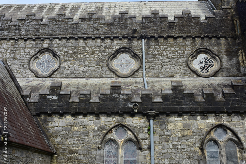 Side wall of stone medieval cathedral with rows of both arched and ...