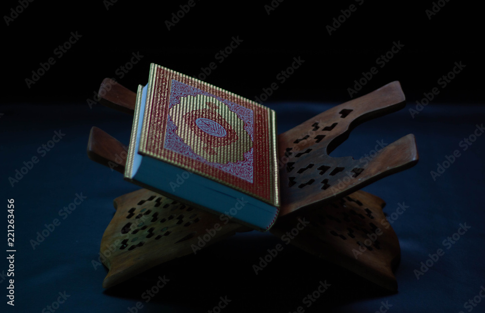 Quran in the mosque - open for prayers The black background of the ...