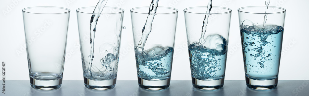 Glass is filling up with water Stock-Foto | Adobe Stock