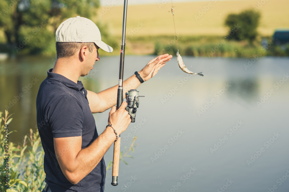 Excellent catch. A man caught a fish on a spinning rod. Crucian on the ...