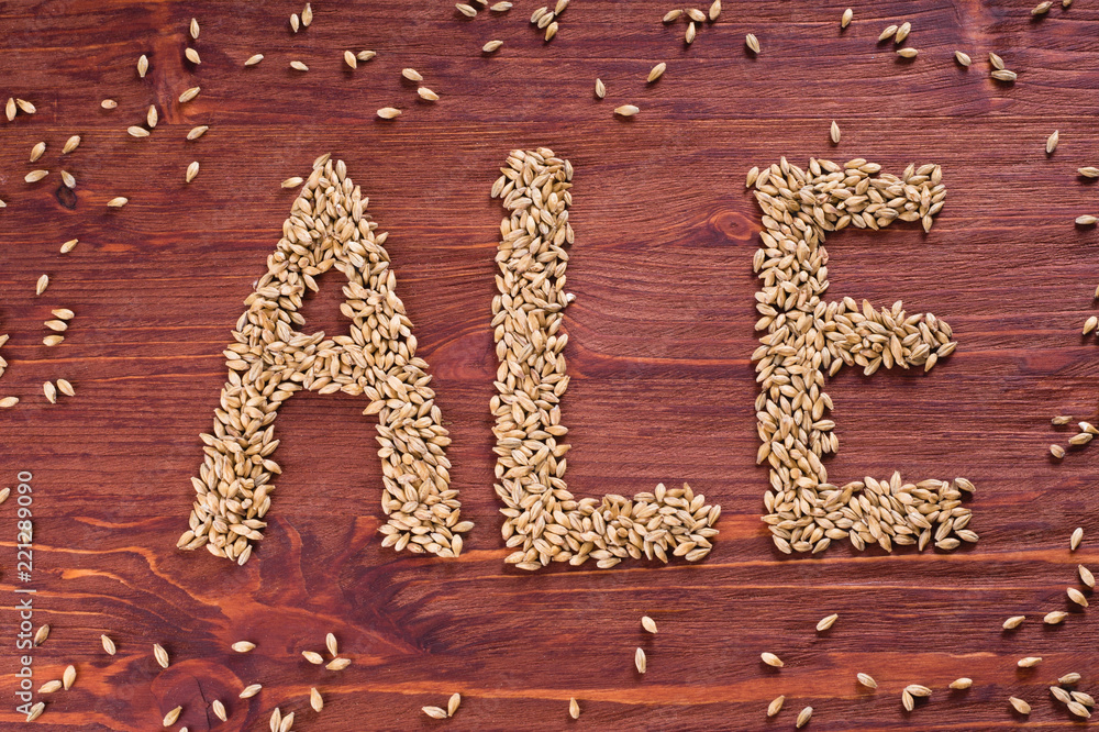 The inscription of ale by malt grains on wood background. Craft beer ...