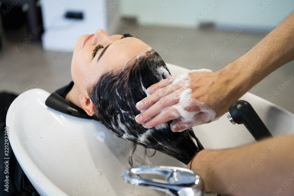 Female client getting hair washed by hairstylist in parlor Stock Photo ...