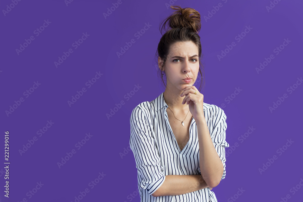 Hmm. A young woman with a questioning expression on her face, with her ...