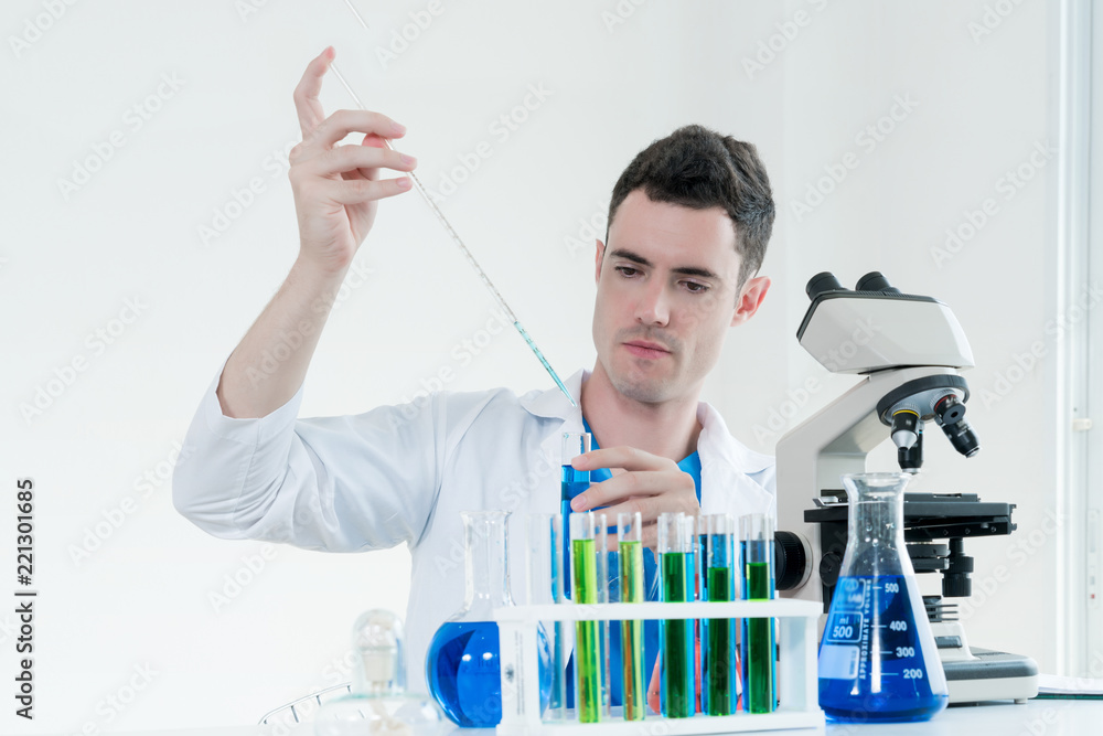 scientist holding tube and working with test tubes in laboratory Stock ...