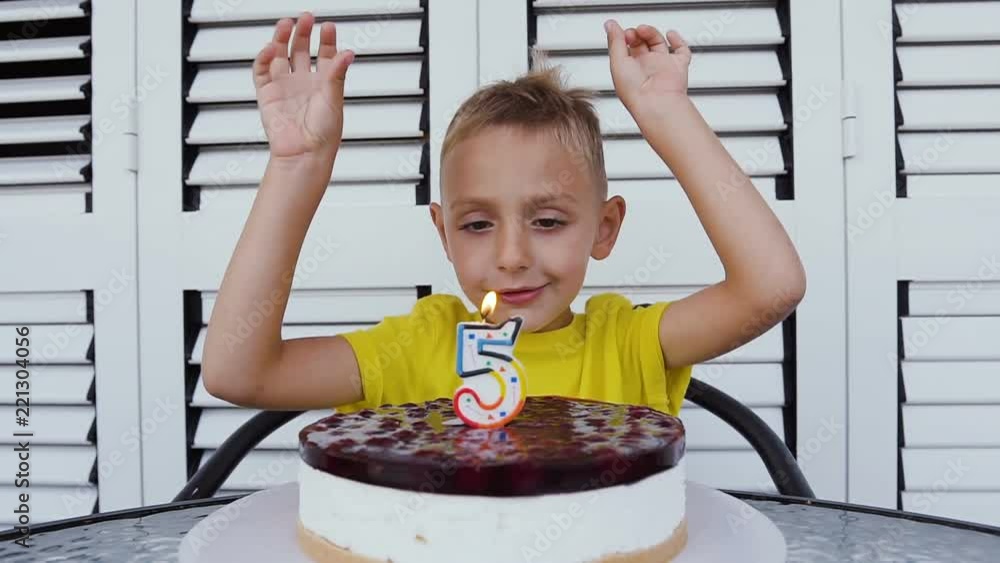 Lovely fifth year old boy in t- shirt, celebrating his birthday ...