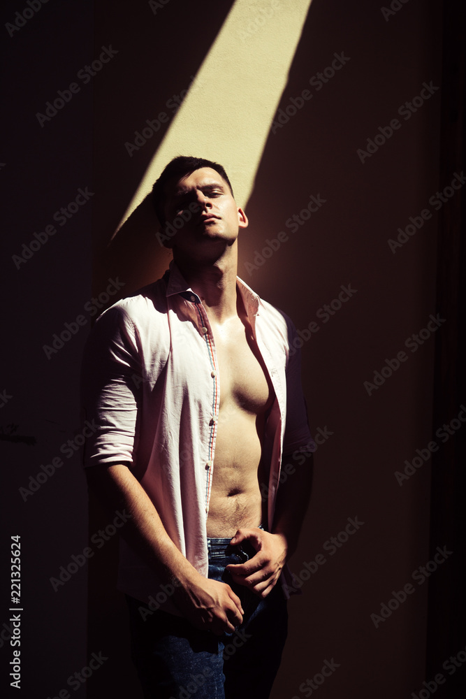 Handsome young man posing in open shirt showing torso Stock Photo ...